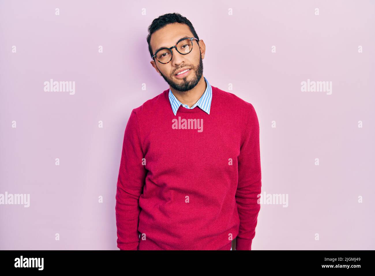 Hispanic man with beard wearing business shirt and glasses looking ...