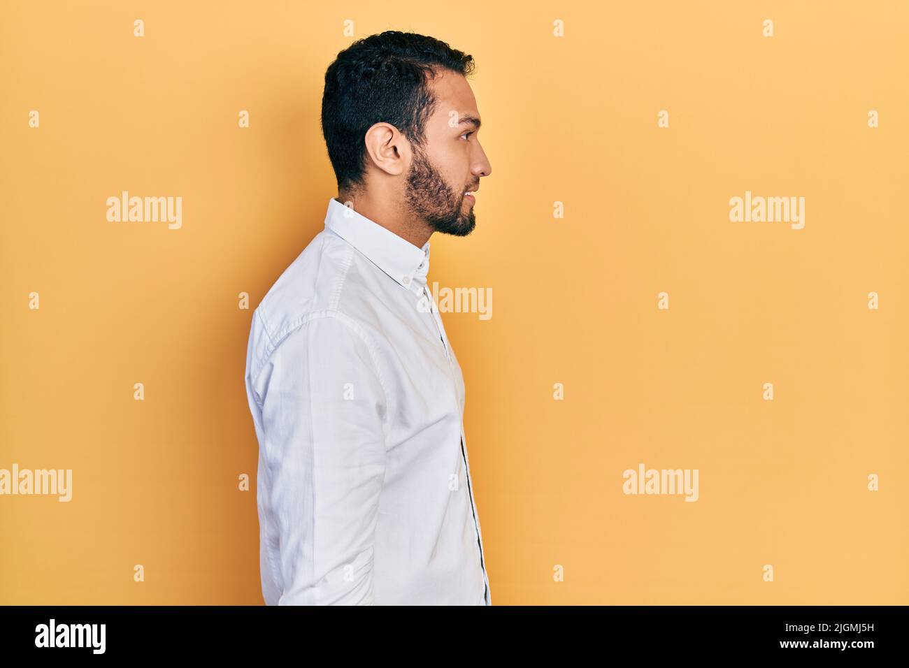 Hispanic man with beard wearing business shirt looking to side, relax ...