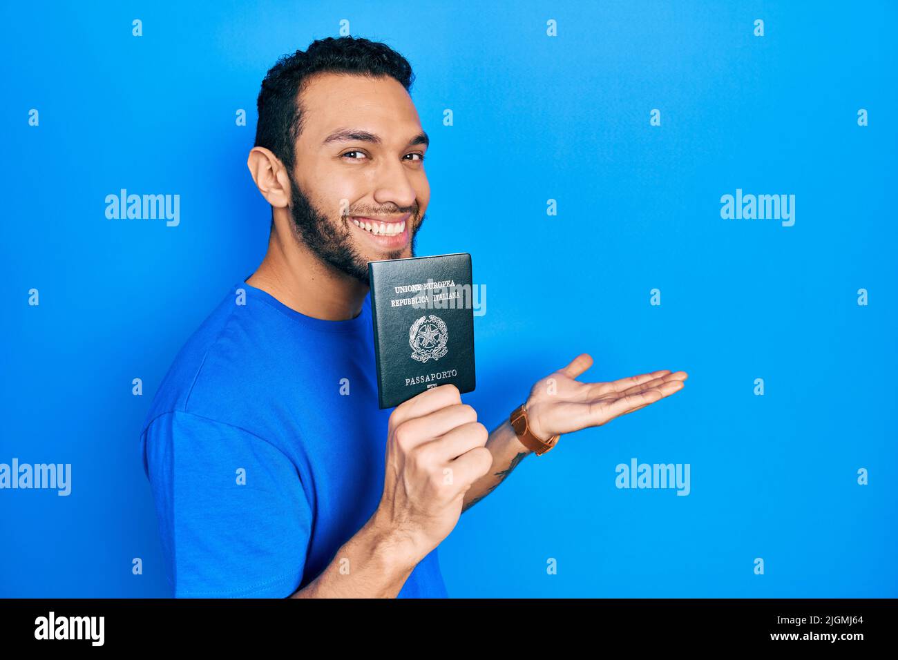 Hispanic man with beard holding italy passport pointing aside with ...