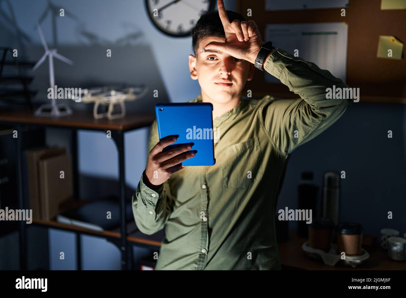 Non binary person using touchpad device at night making fun of people ...