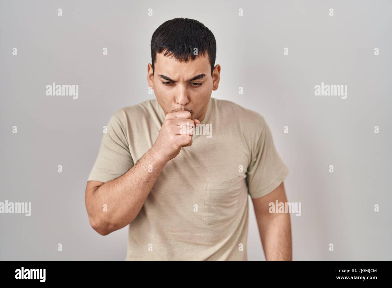 Young arab man wearing casual t shirt feeling unwell and coughing as ...