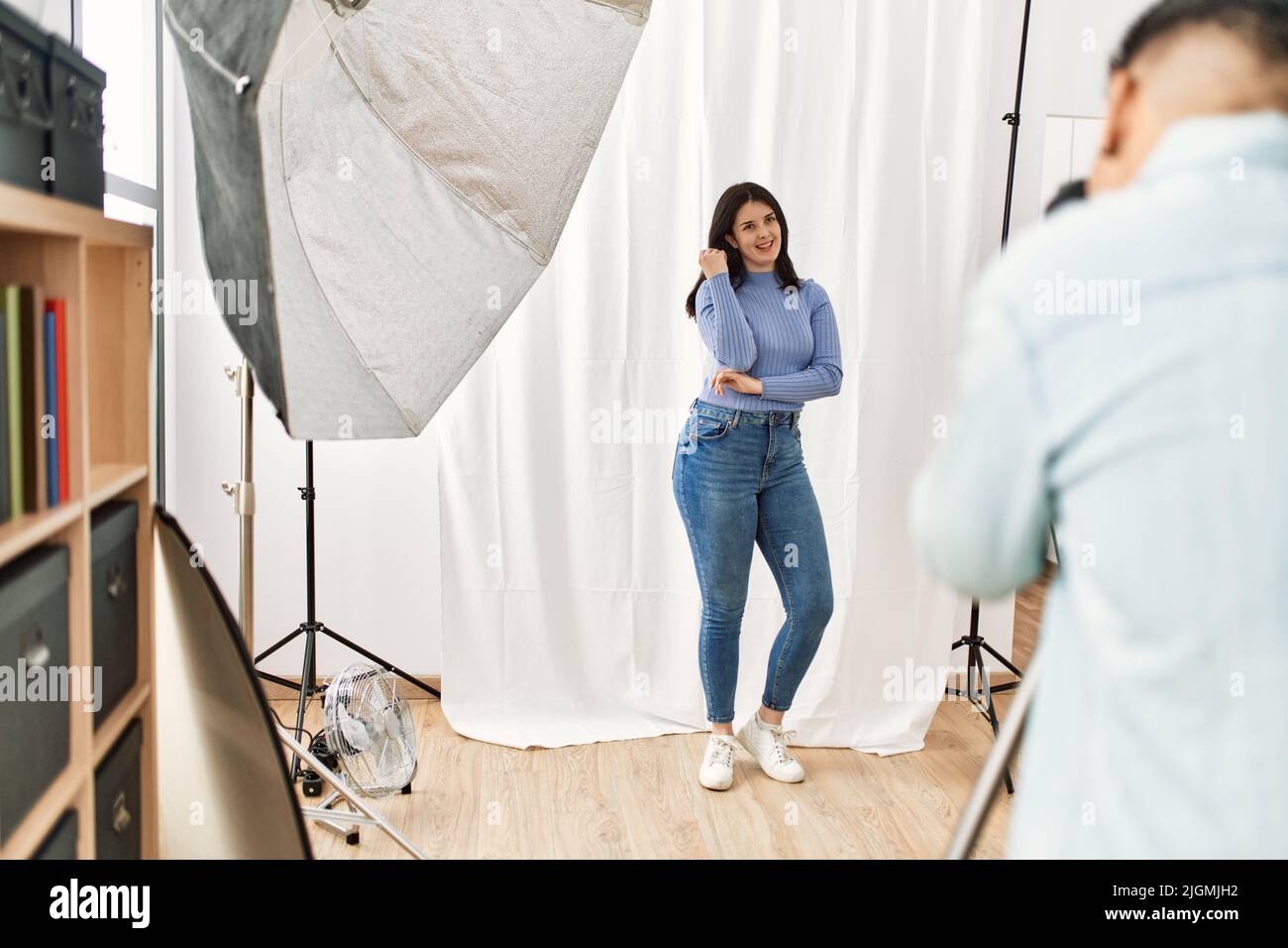 Beautiful model posing for professional photographer man at photography ...