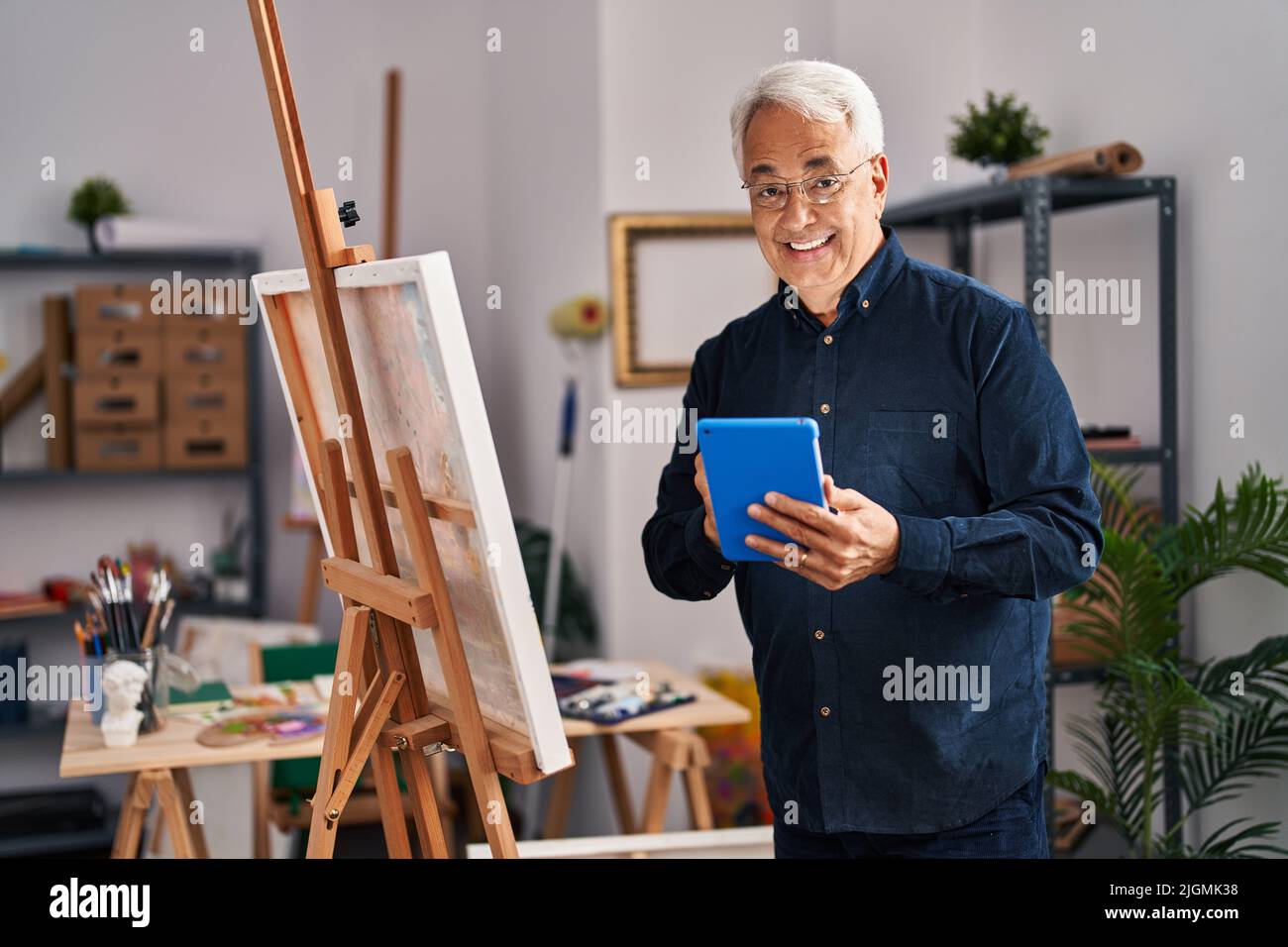 Senior man using touchpad drawing at art studio Stock Photo - Alamy