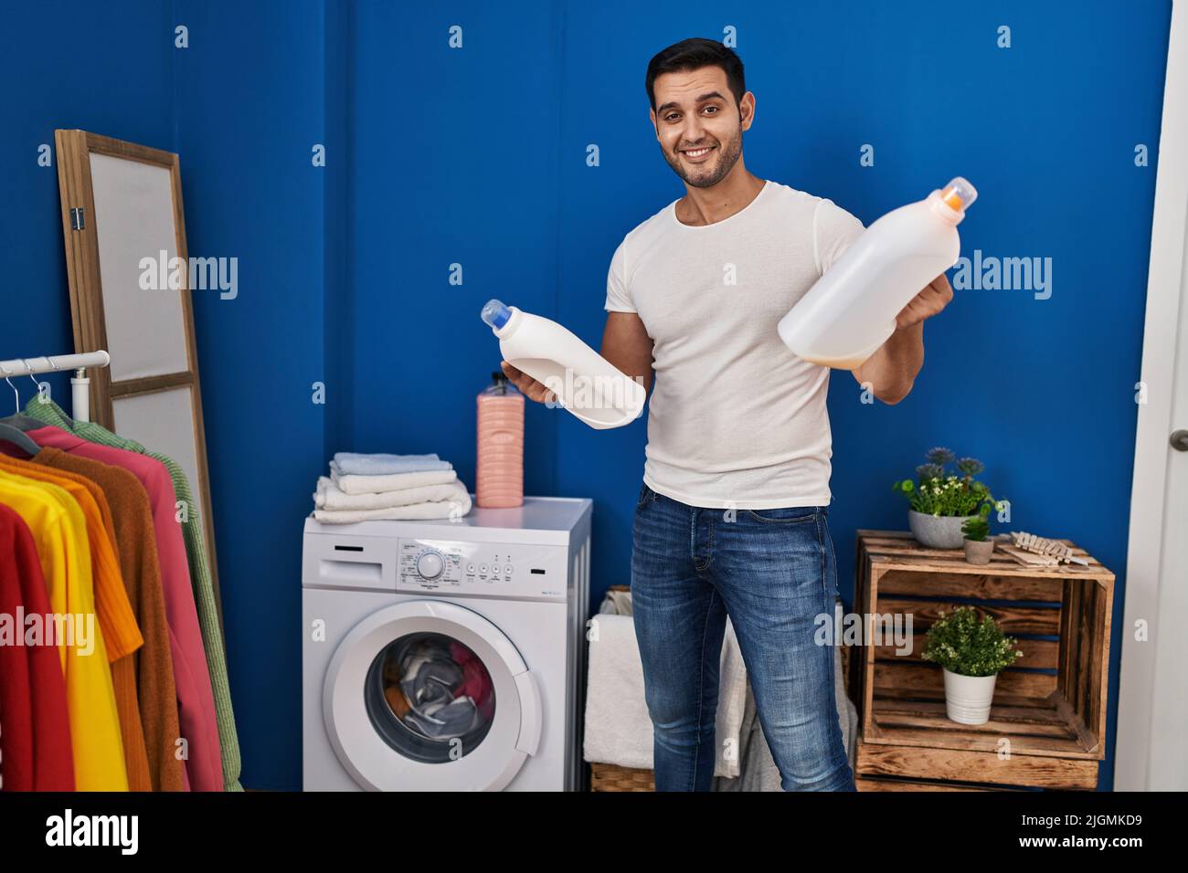 Hispanic man holding laundry hi-res stock photography and images - Alamy