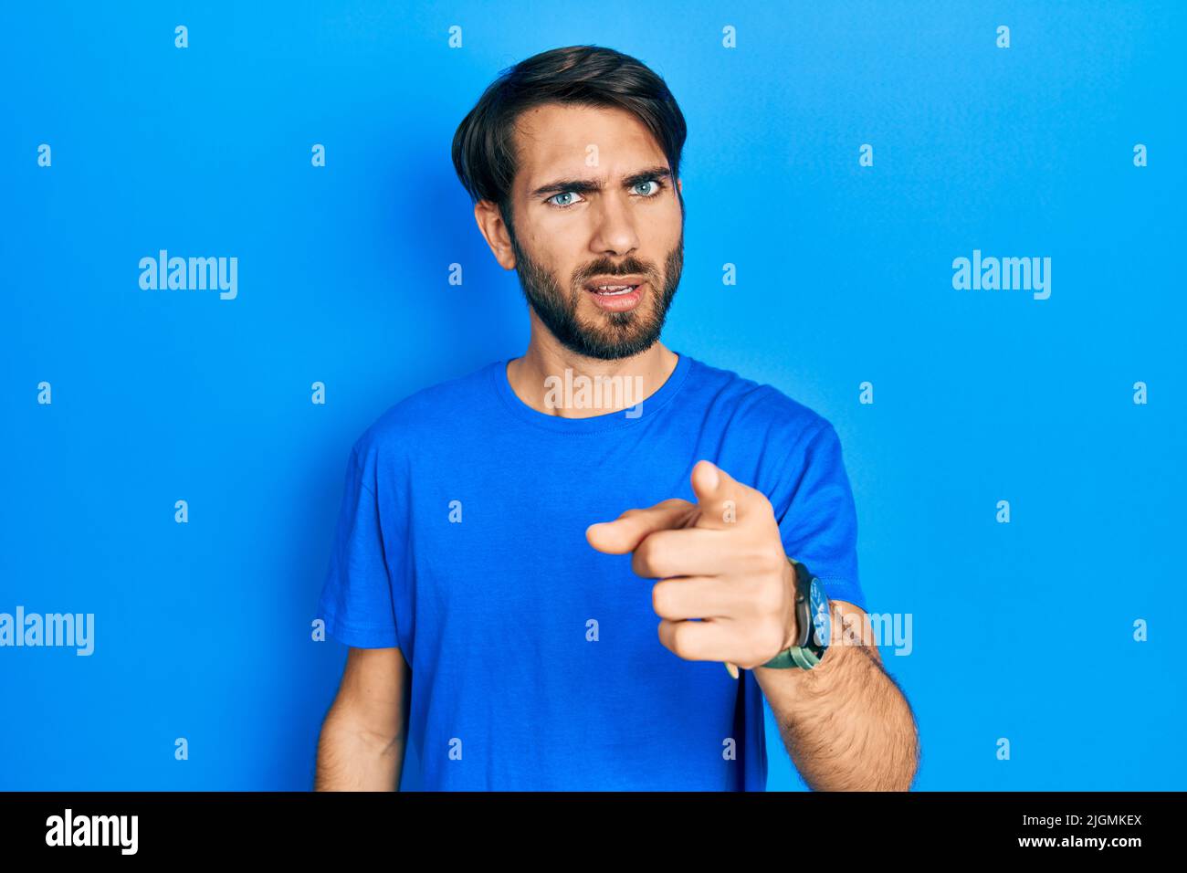 Young hispanic man wearing casual clothes pointing displeased and ...
