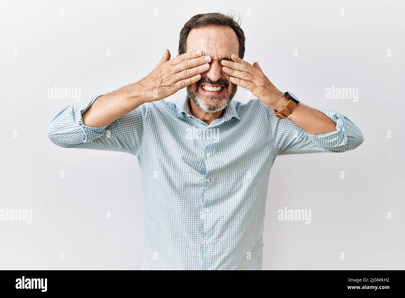 Middle age hispanic man with beard standing over isolated background ...