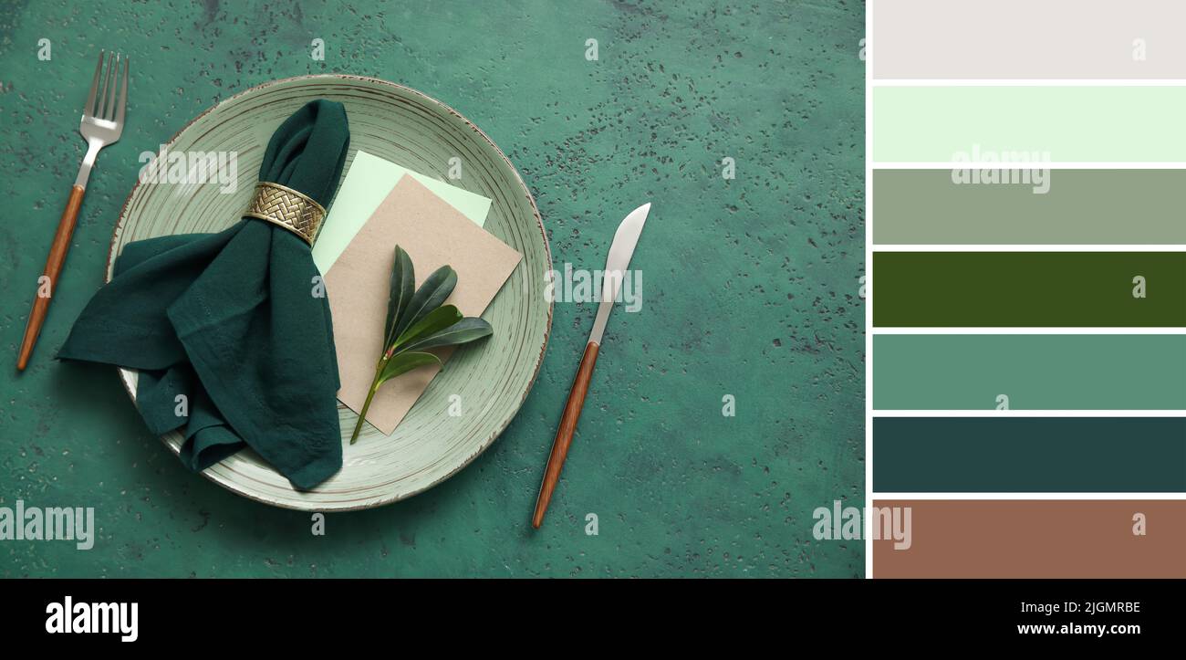 Simple beautiful table setting on green background. Different color ...