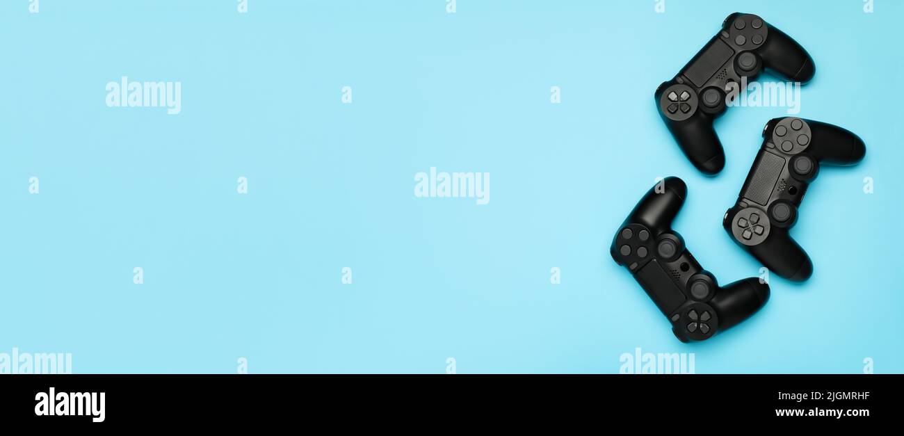 Modern game pads on light blue background with space for text Stock ...