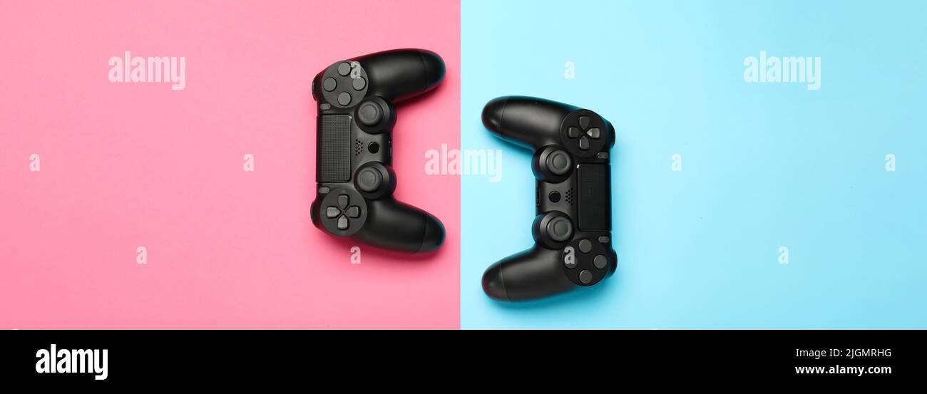 Modern game pads on color background Stock Photo - Alamy