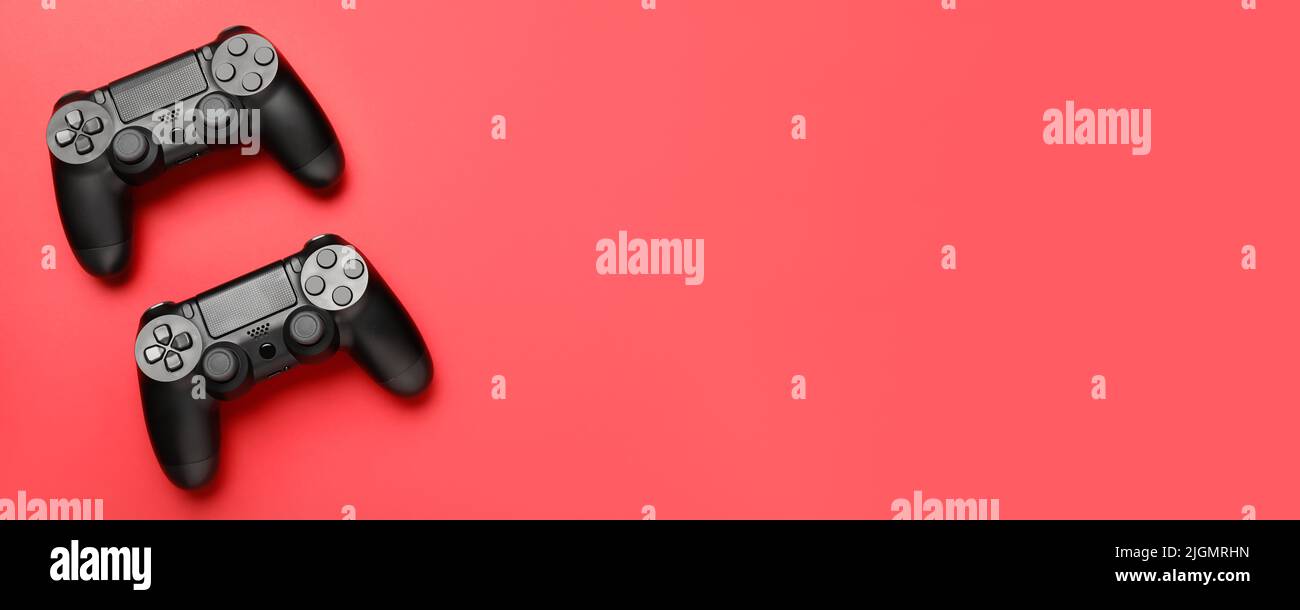 Modern game pads on red background with space for text Stock Photo - Alamy