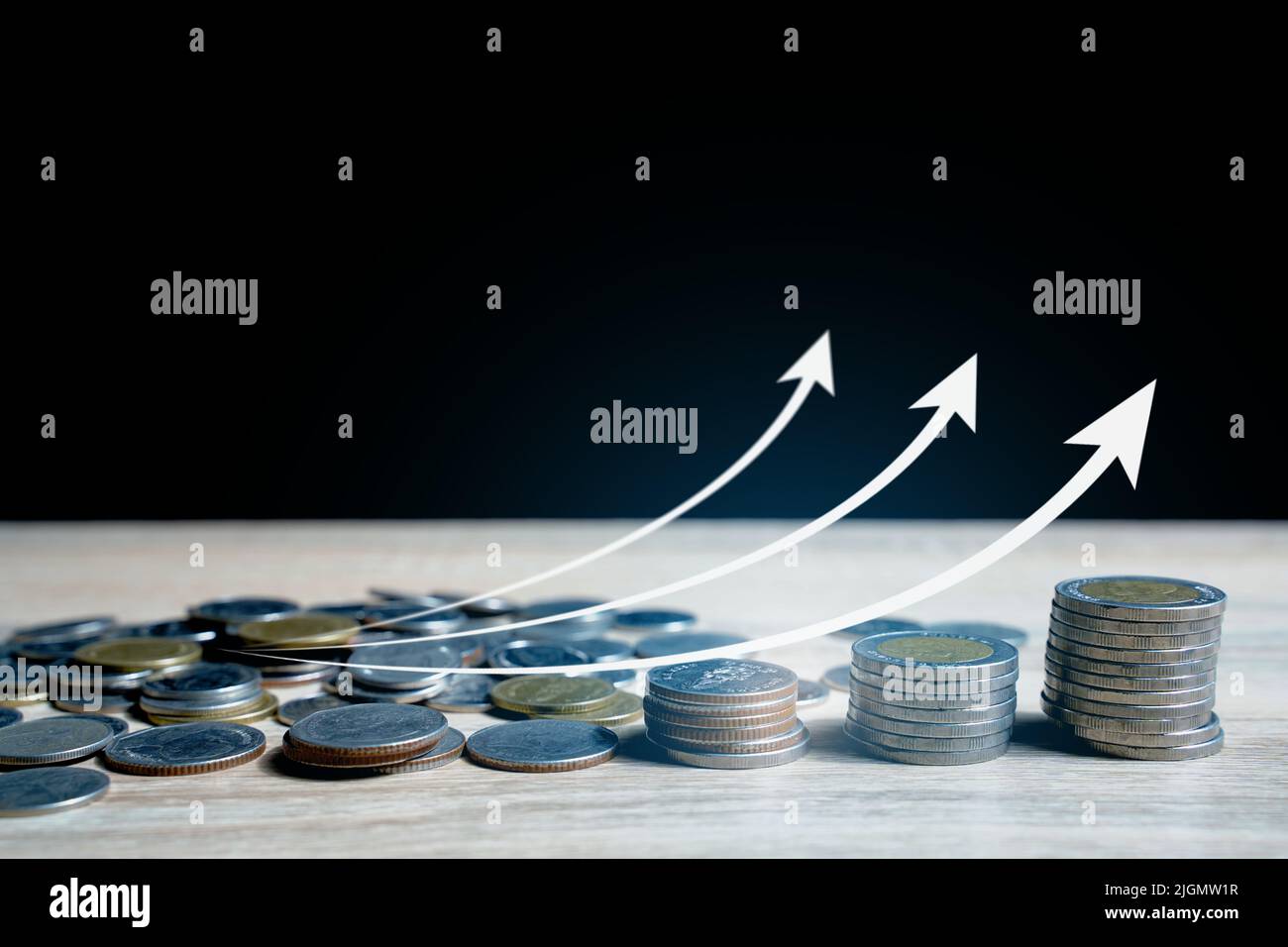 The stacked coins have a graph showing the monetary volatility ...