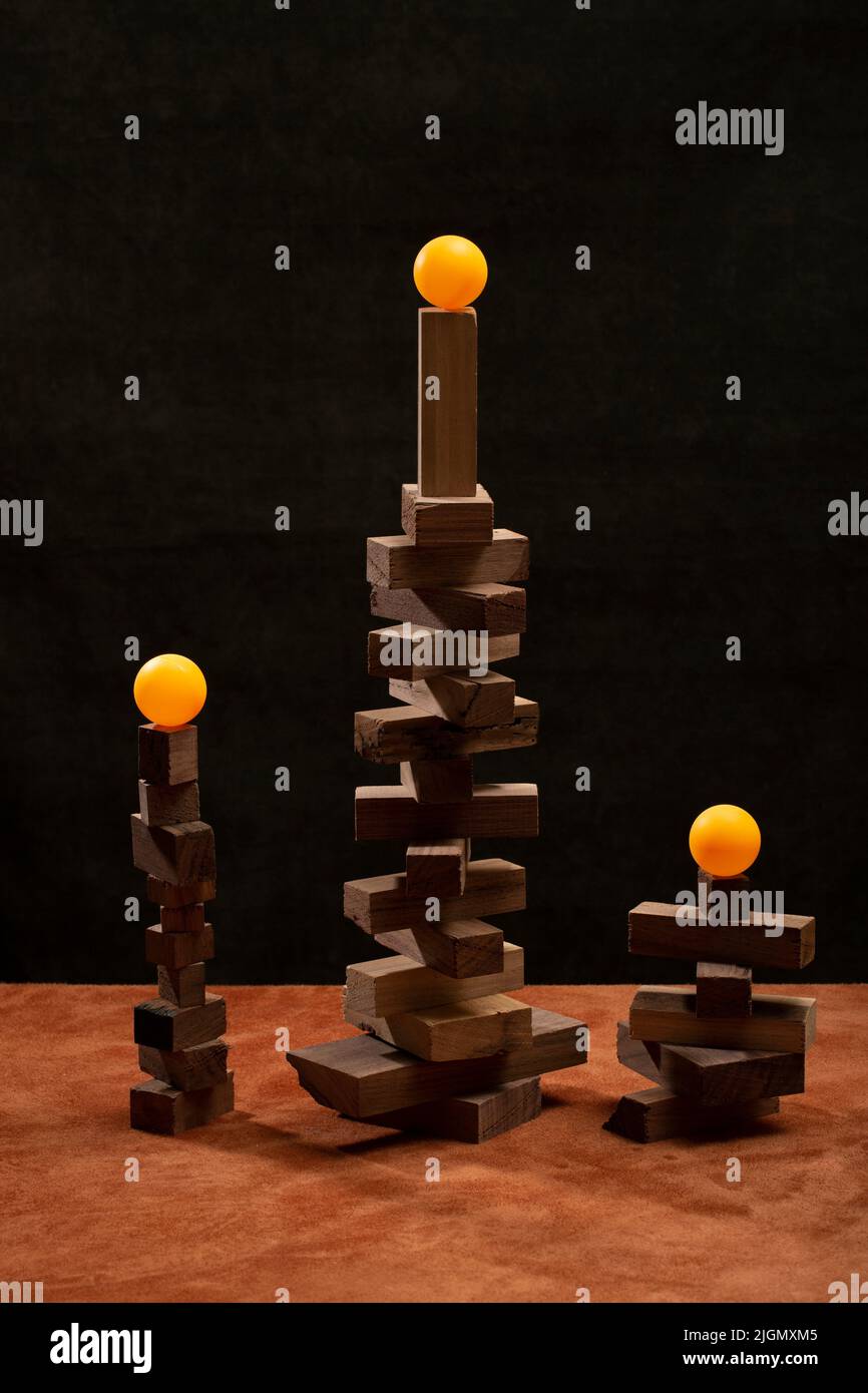 Figures made of wooden cubes with orange balls on top Stock Photo - Alamy