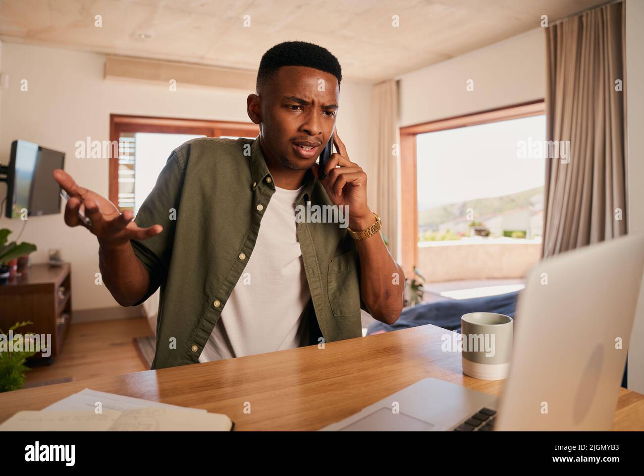 Young adult black African-American male in a heated, angry, frustrated ...