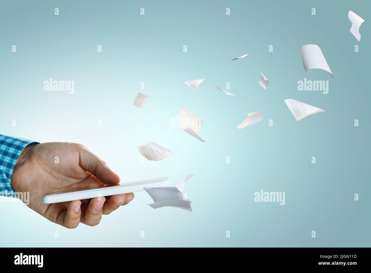 Hand holding smart mobile phone and paper flying away Stock Photo - Alamy