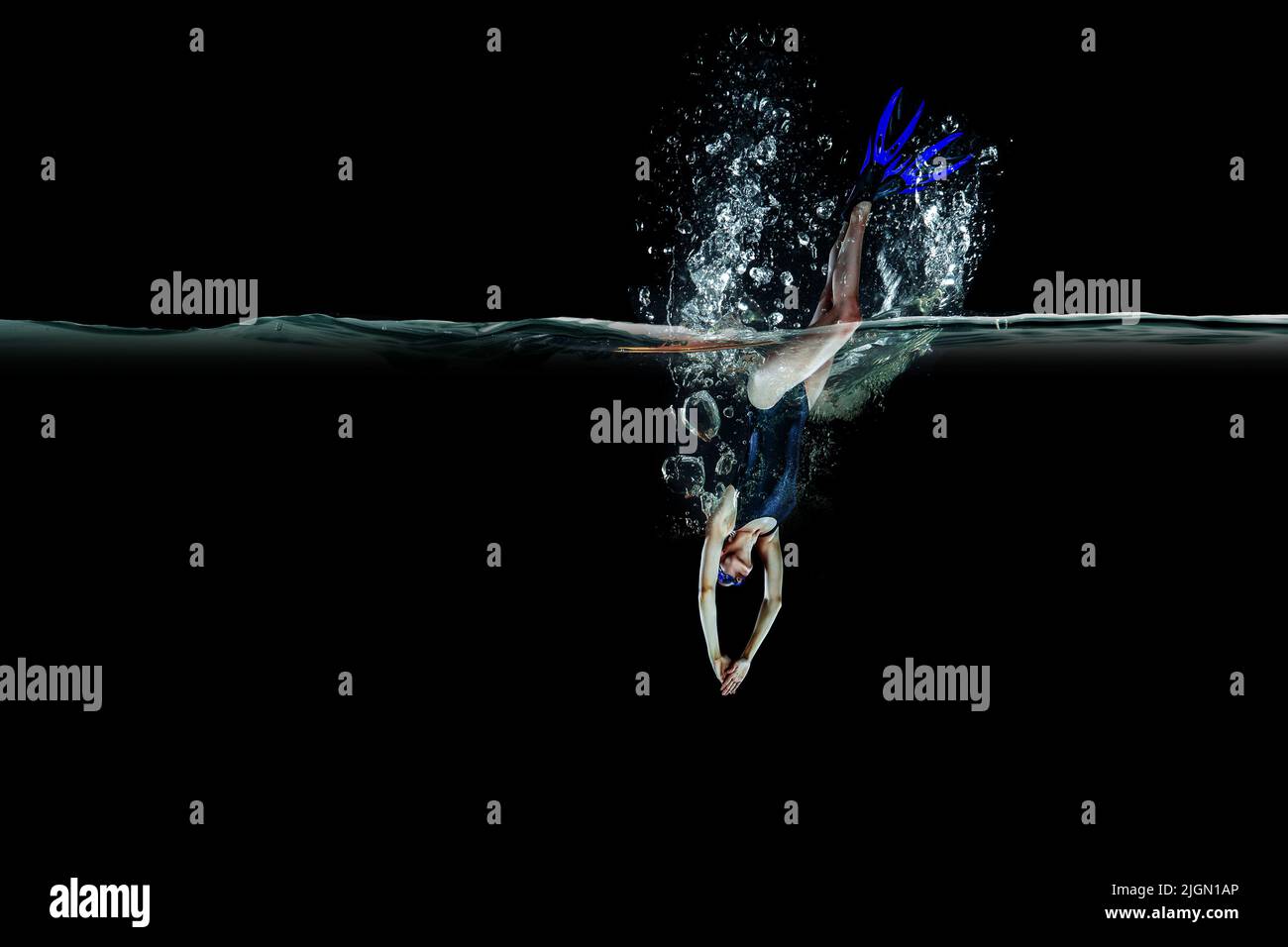 Professional woman swimmer on a wave Stock Photo - Alamy