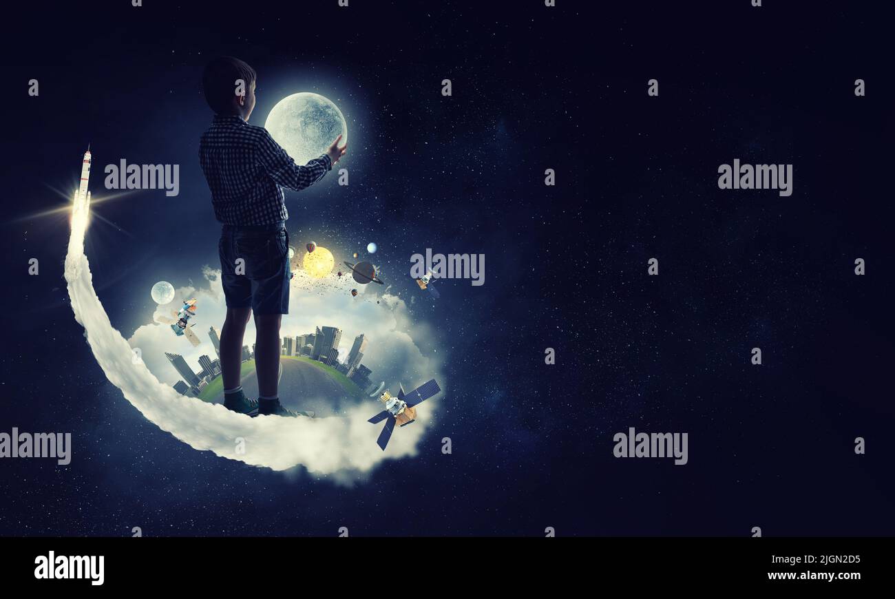 Boy holding moon at night Stock Photo - Alamy