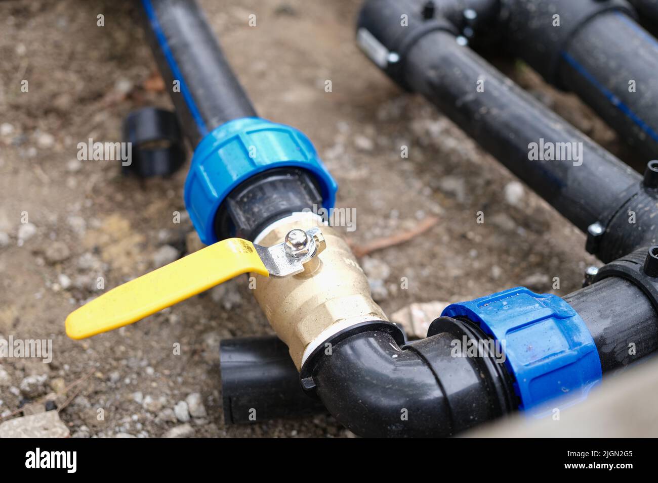 Elbow fitting of pvc pipes at bend with yellow faucet Stock Photo - Alamy