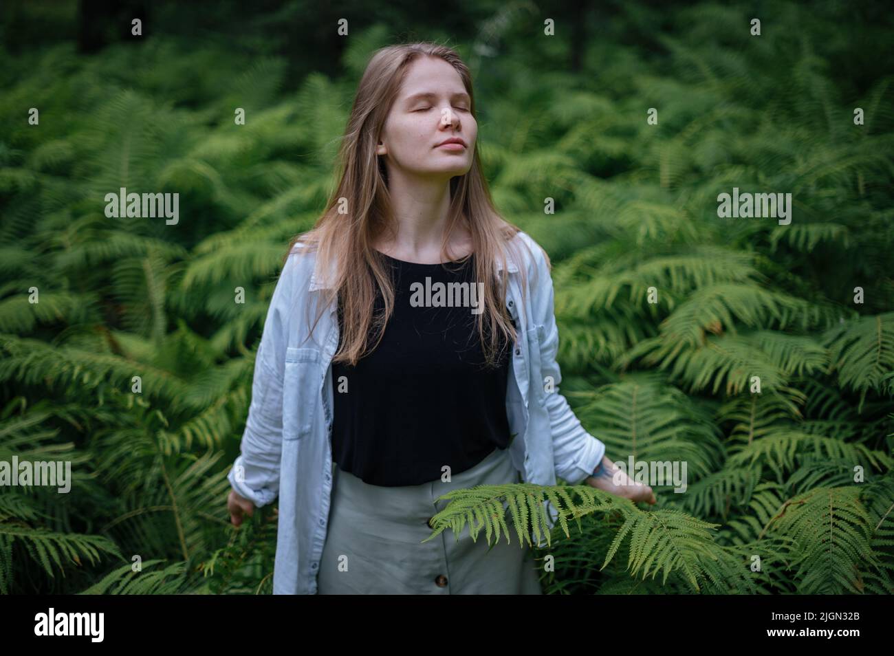 Practice of meditation and interaction with nature. Girl in green ...