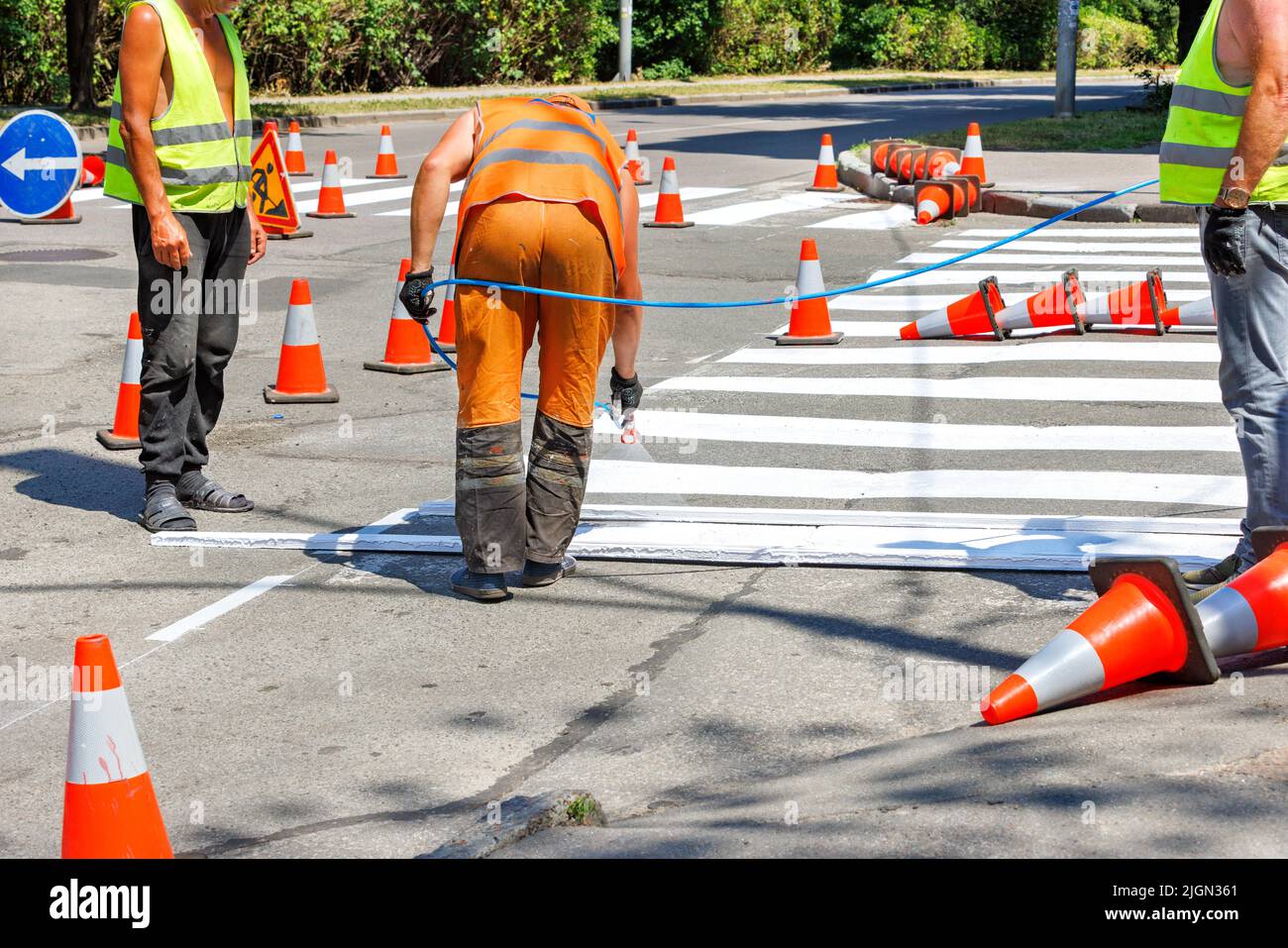 A team of road workers on a fenced section of the carriageway with a ...
