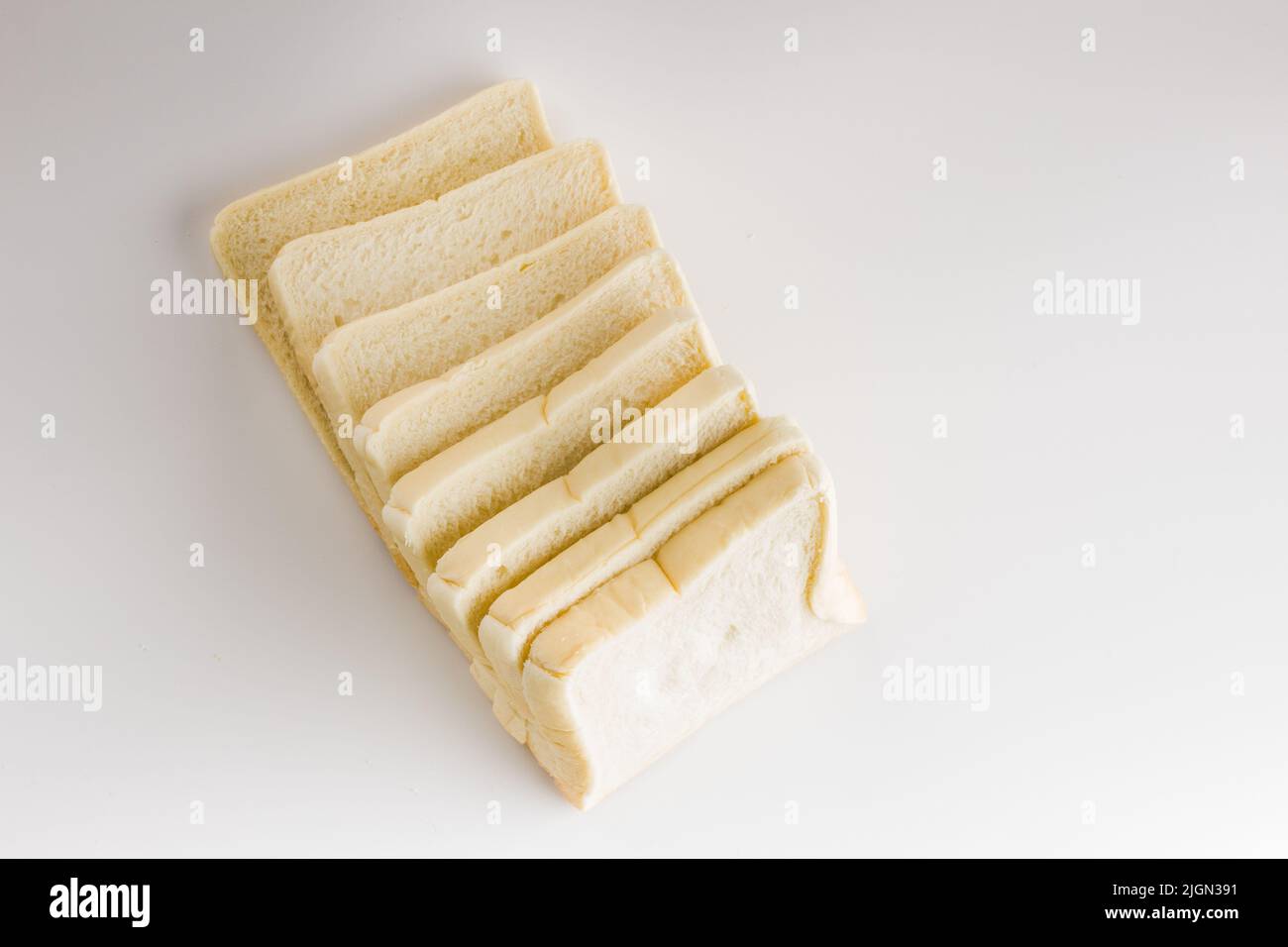Loaf of sliced white bread on white background Stock Photo - Alamy
