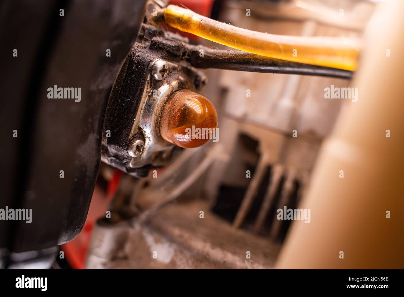 Close-up of a small carburettor fuel primer. The engine of a gasoline ...
