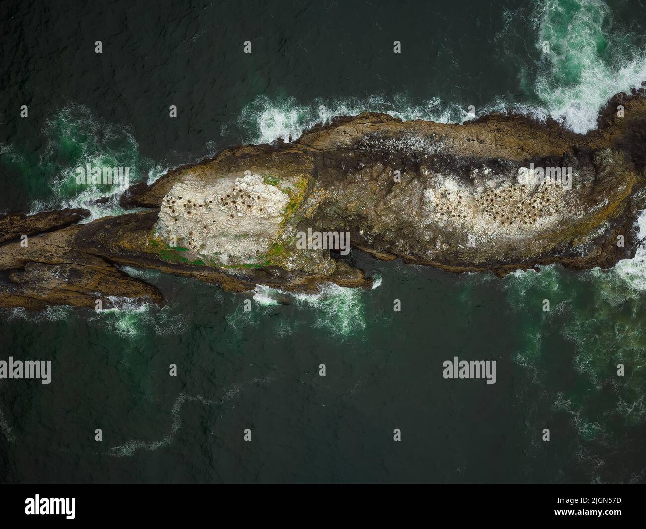 Seascape. An unusually shaped small island in the middle of the ocean ...
