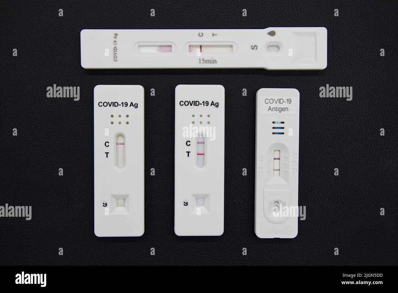 Multiple Covid-19 antigen test kits isolated on black background ...