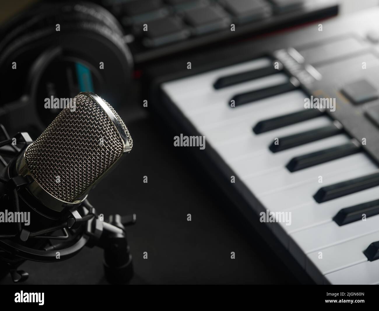 On a dark gray background, a professional synthesizer midi keyboard ...