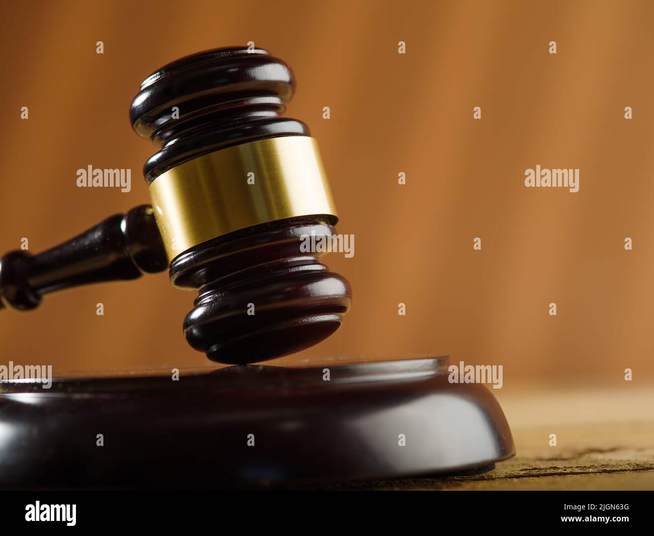 Close-up. Wooden gavel of the judge and in the background an open book ...