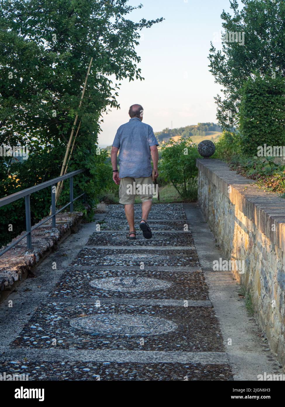 old man with sky pole walking around in garden and farm in summer ...