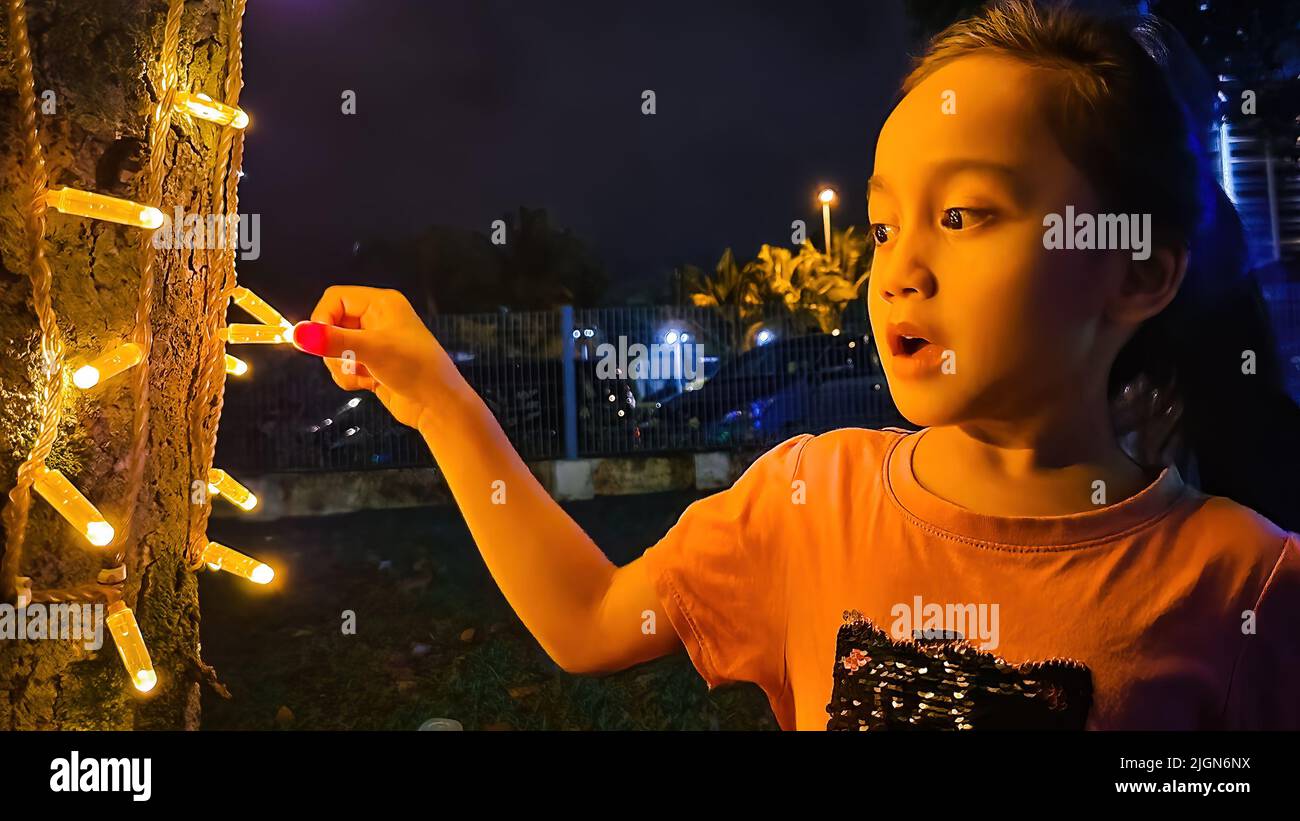 Neon portrait of young girl with touching the LED lights. Lifestyle of ...