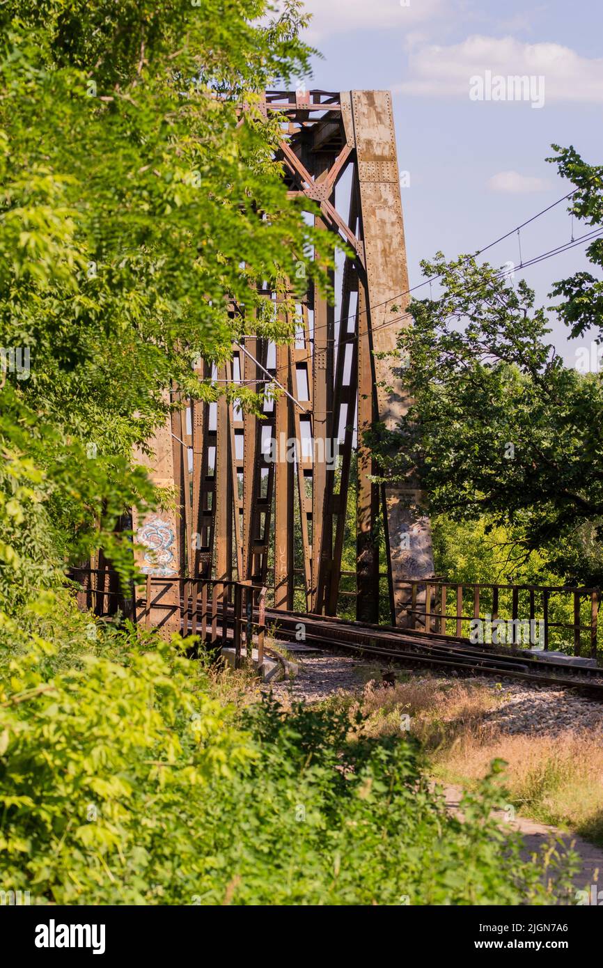 The metal structure of the railway viaduct over the river against the ...