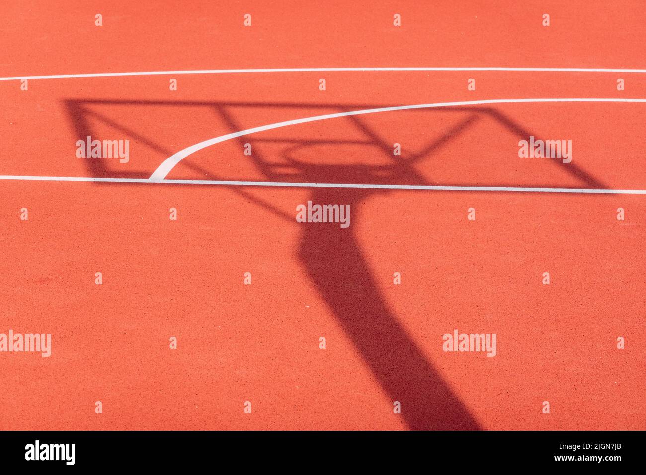 Shadow of the rack with shield and basketball ring on orange basketball ...