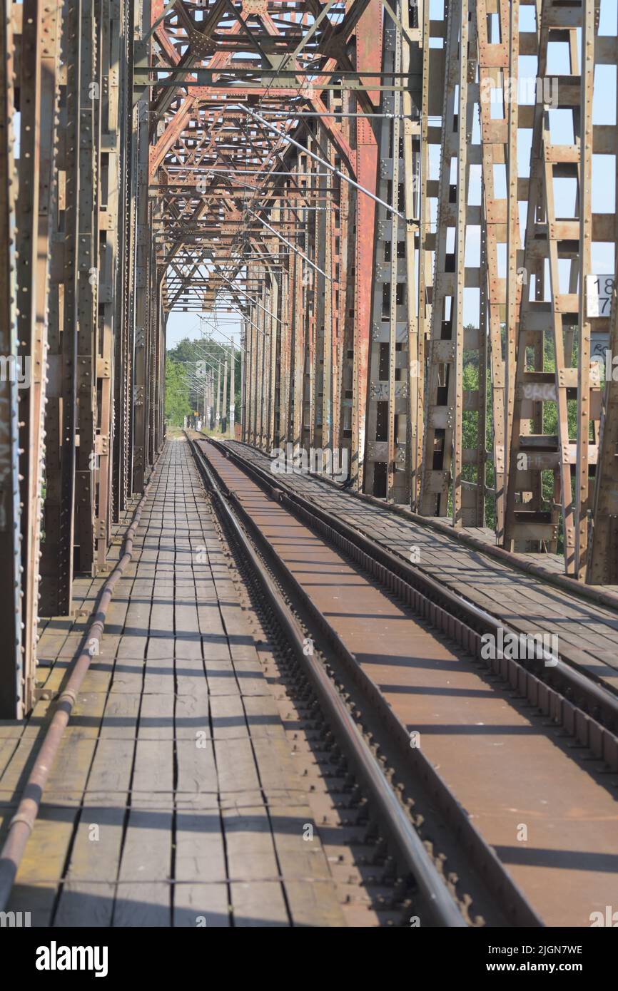 The metal structure of the railway viaduct over the river against the ...