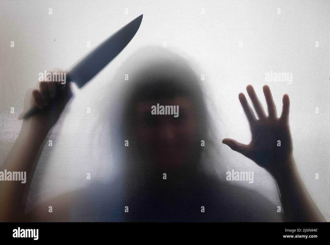 Horror, halloween background - Shadowy figure behind glass holding a ...