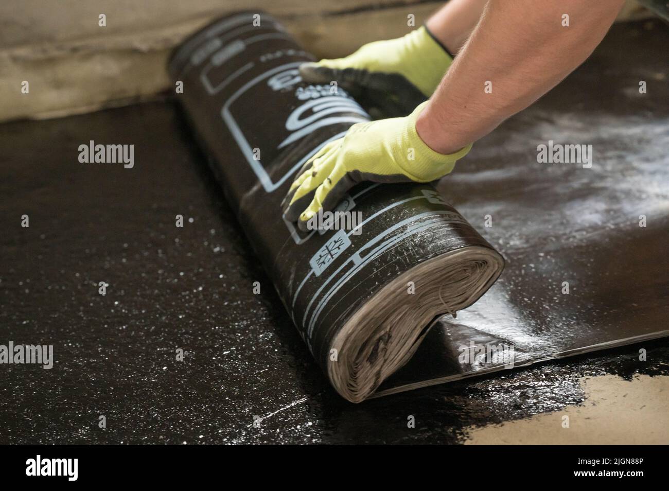 installation of waterproofing coating on the floor with a blowtorch and ...