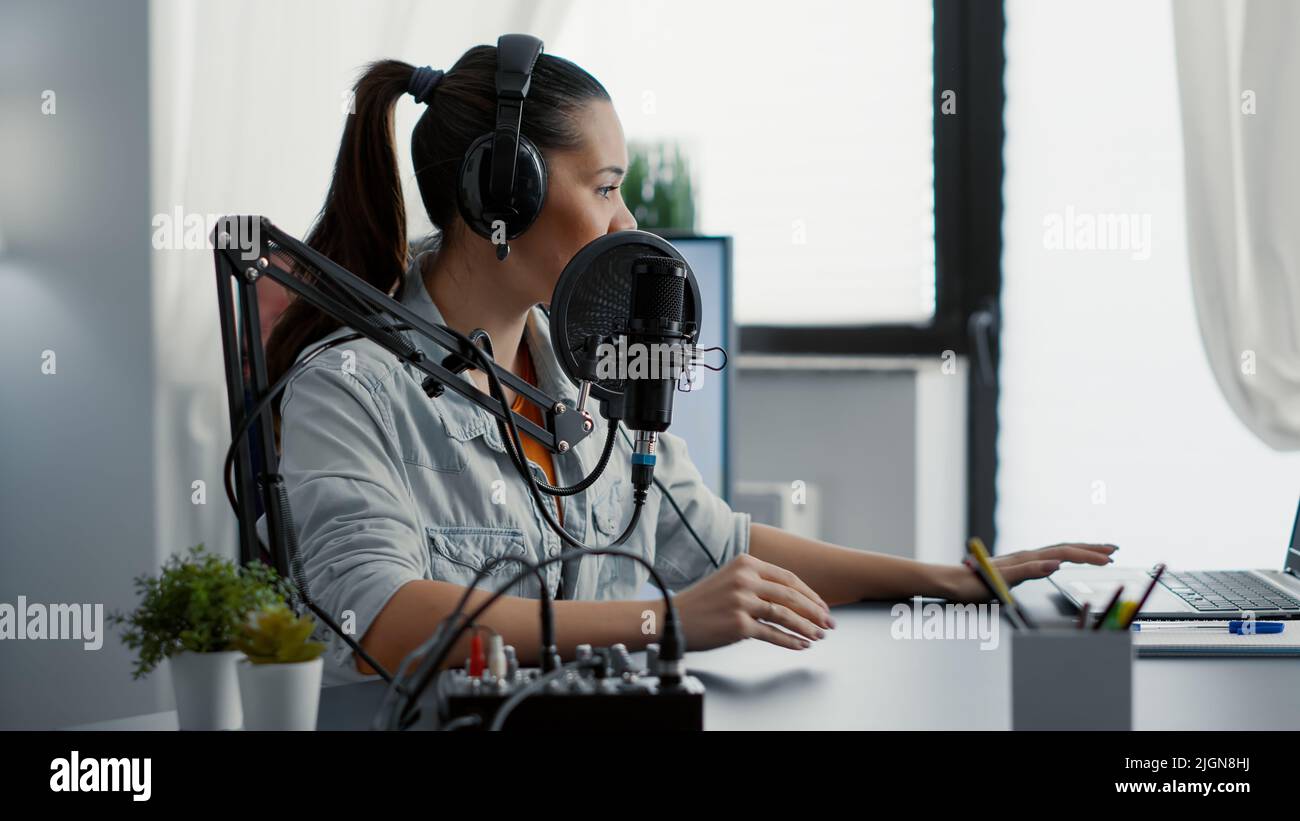 Creative podcaster hosting internet live talk show while sitting in ...
