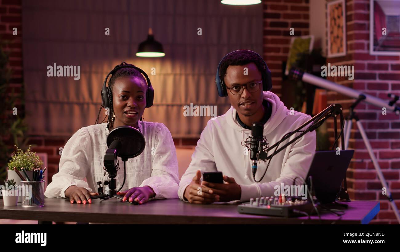 African american influencer couple streaming live dual vlog talking ...