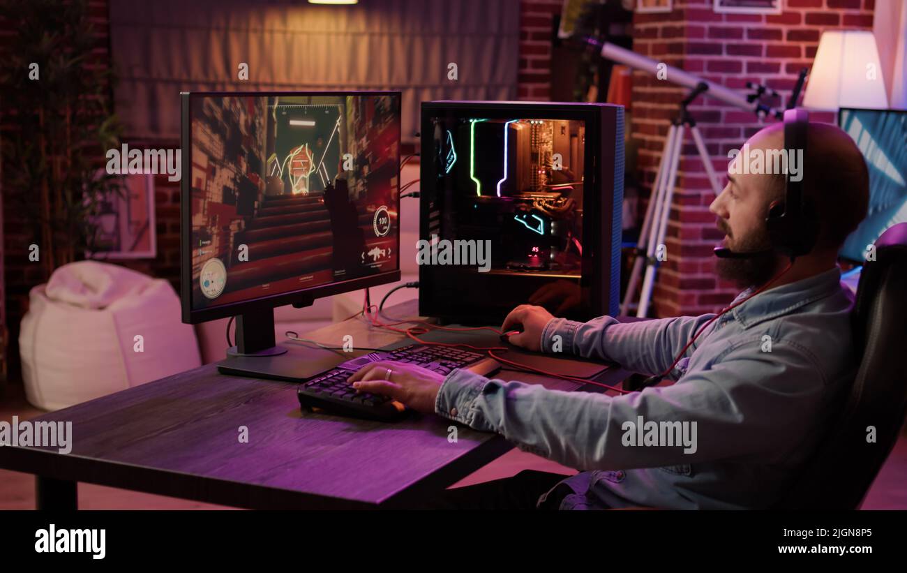 Caucasian man enjoying video game playing action first person shooter ...