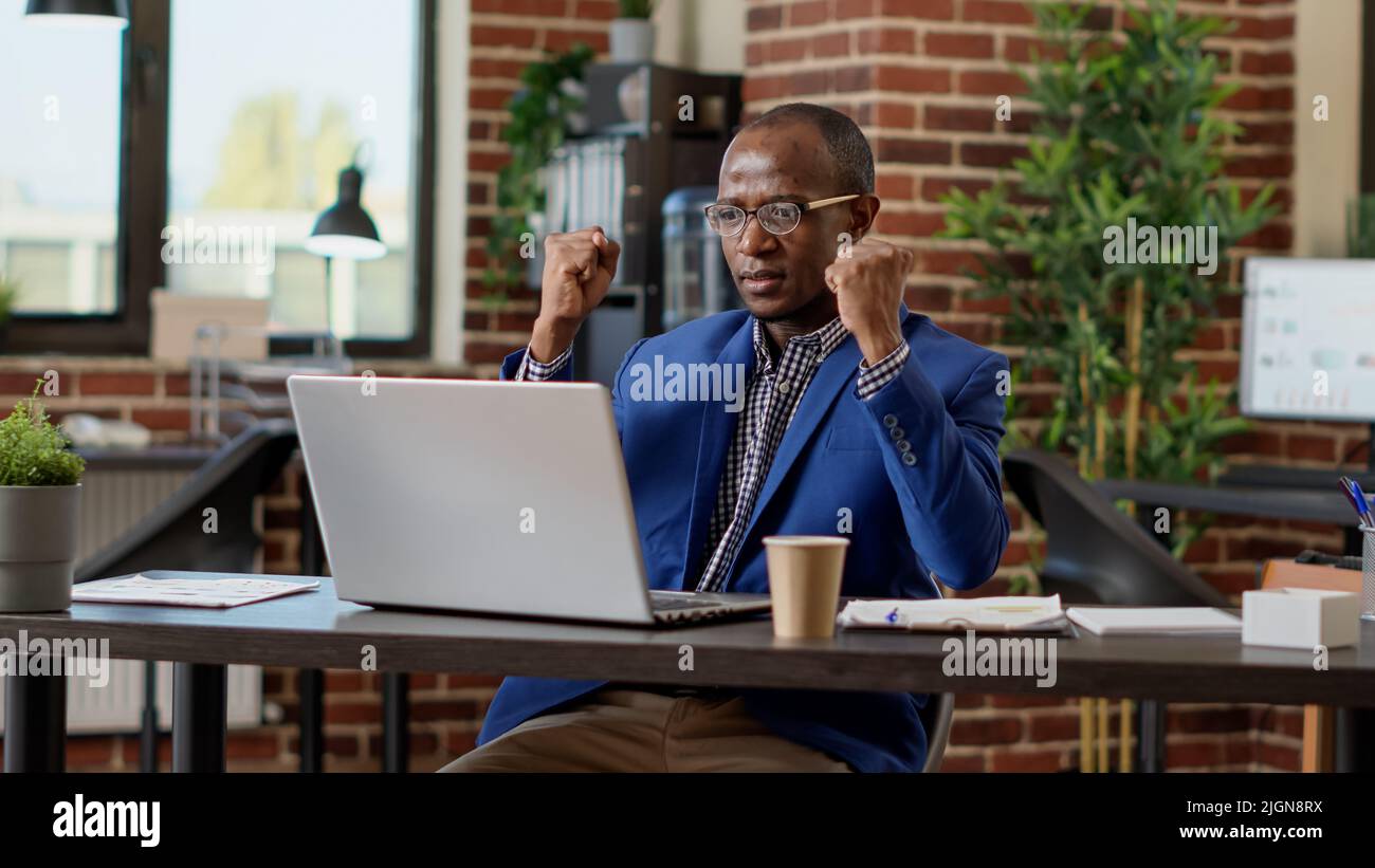 Happy businessman celebrating project success in startup office ...