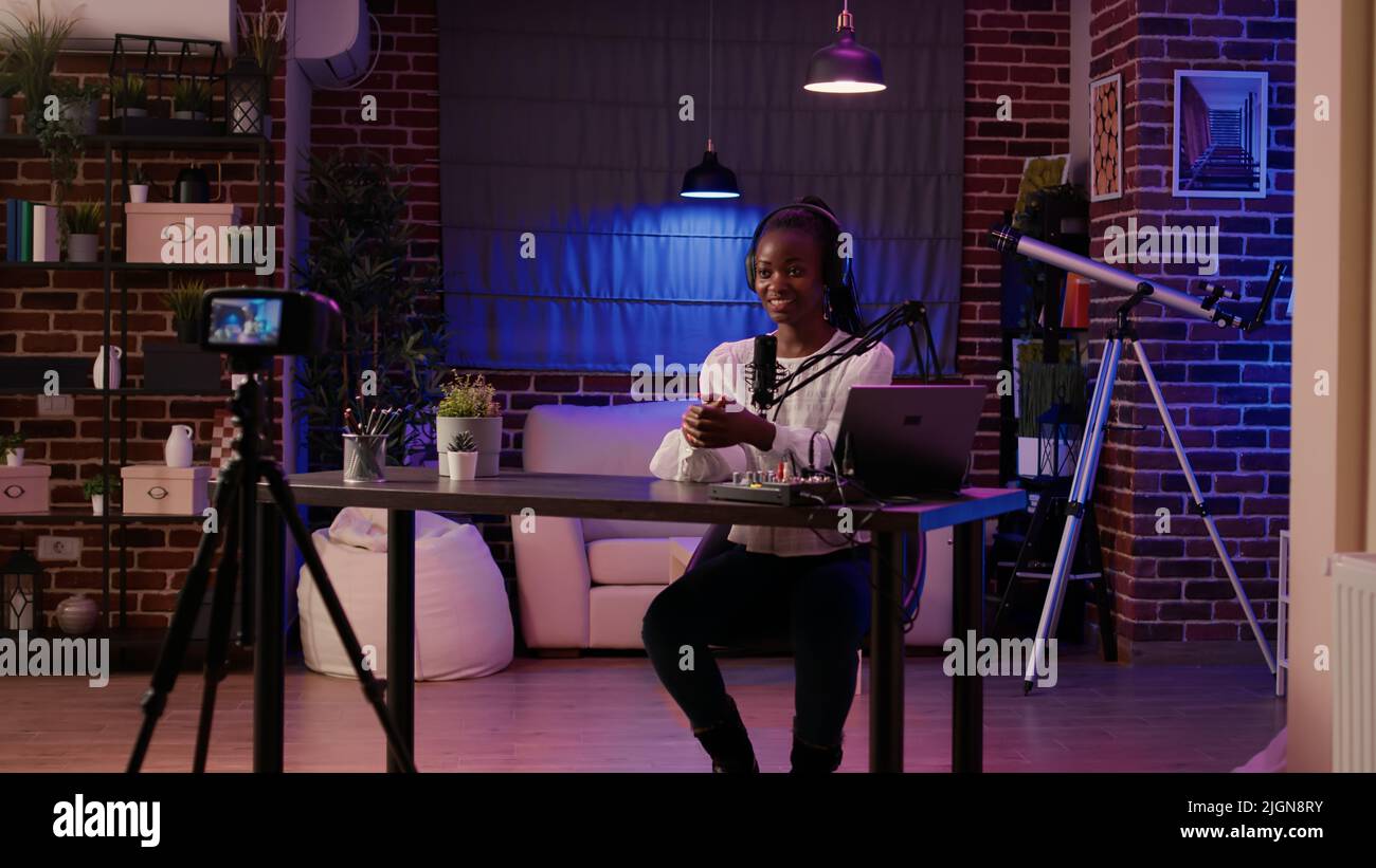 African american woman vlogger greeting audience while recording vlog ...