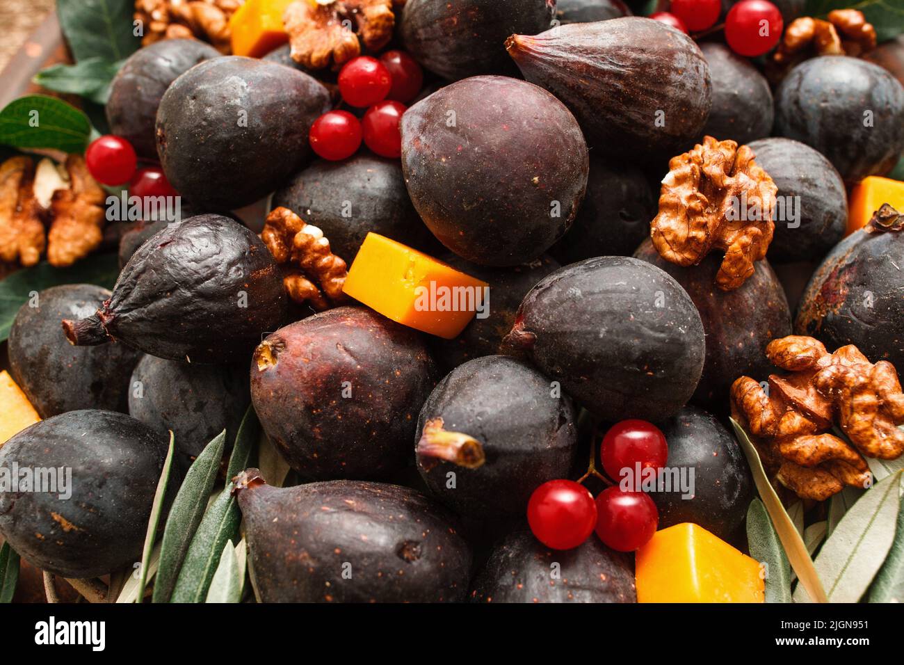 Figs walnuts cheese and viburnum background Stock Photo - Alamy