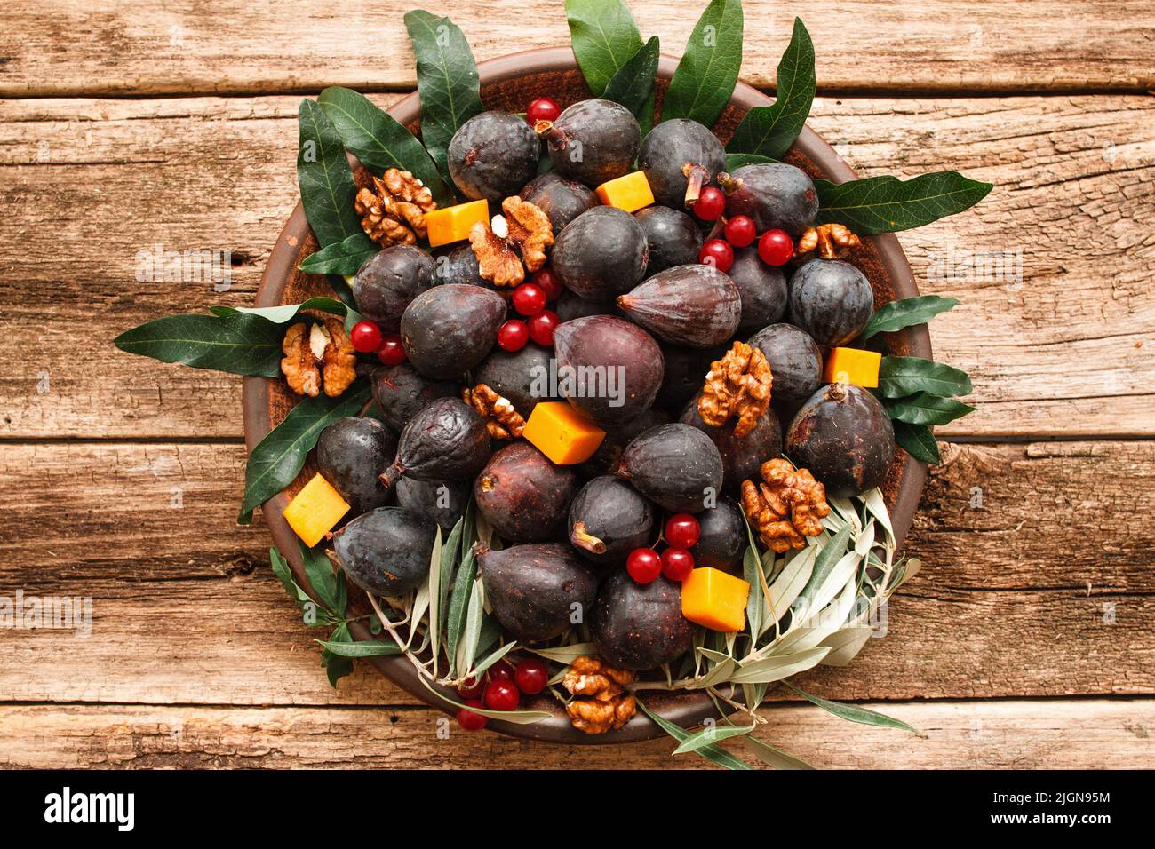 Mix of figs with nuts and red berries flat lay Stock Photo - Alamy