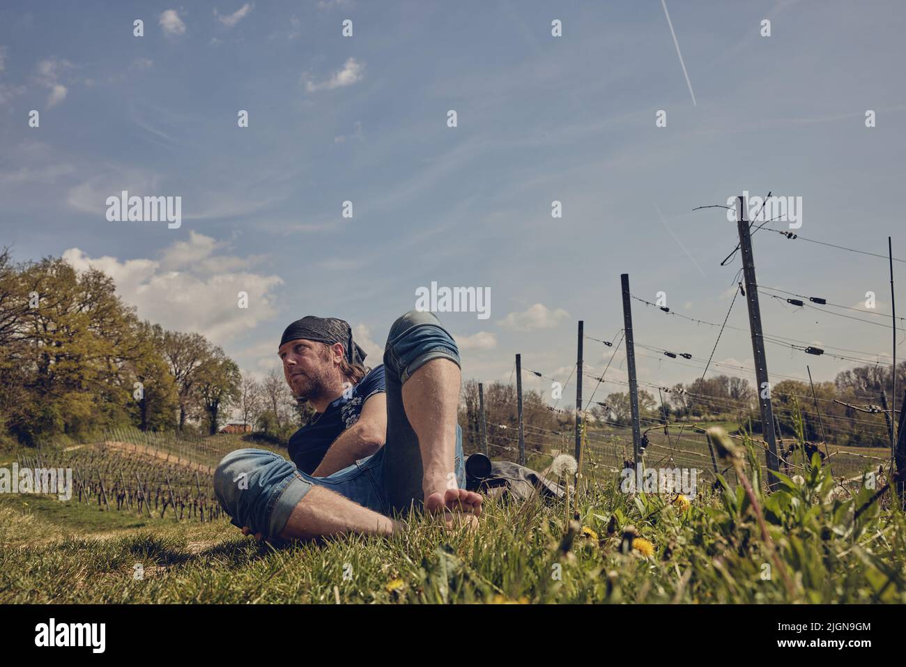Mig aged man lying in the grass Stock Photo - Alamy