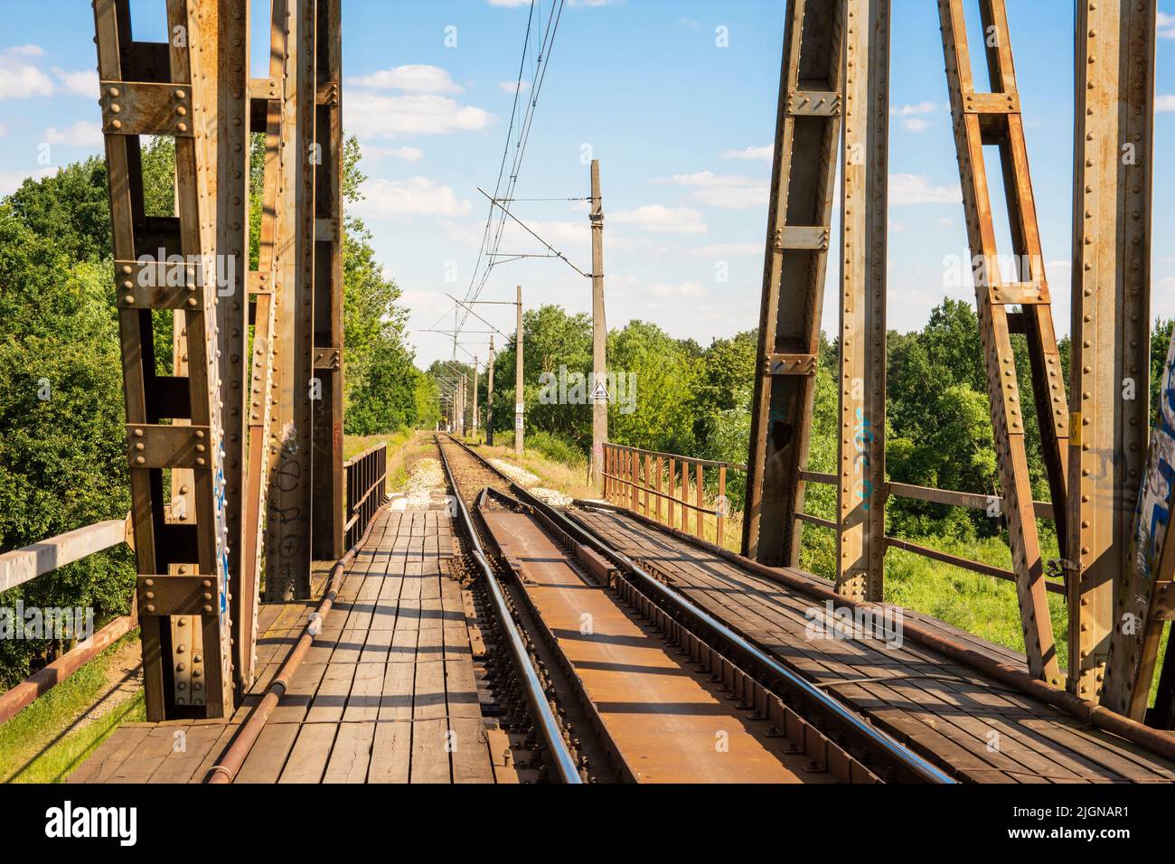 The metal structure of the railway viaduct over the river against the ...