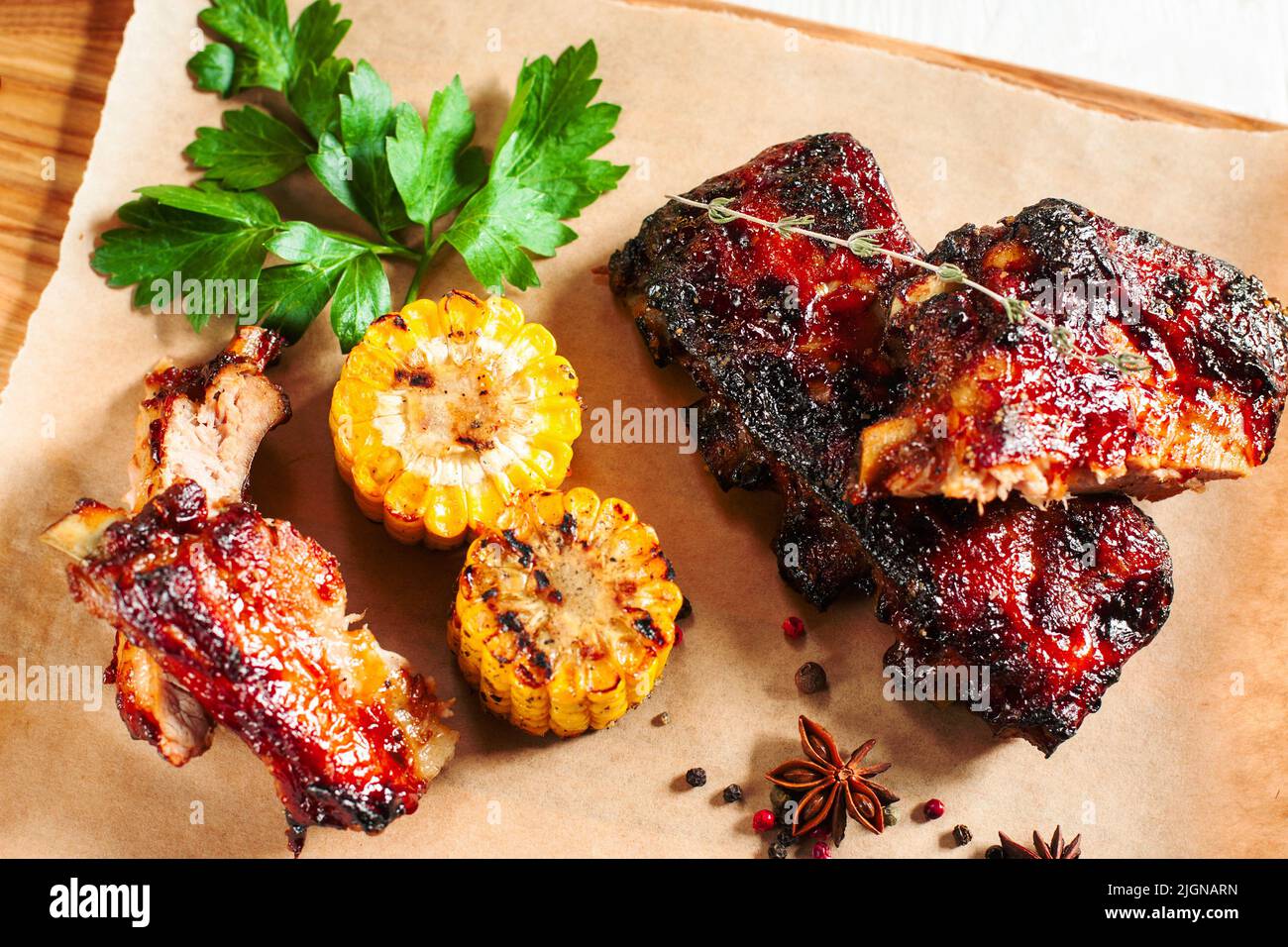 Grilled pork ribs with corn on wood flat lay Stock Photo - Alamy