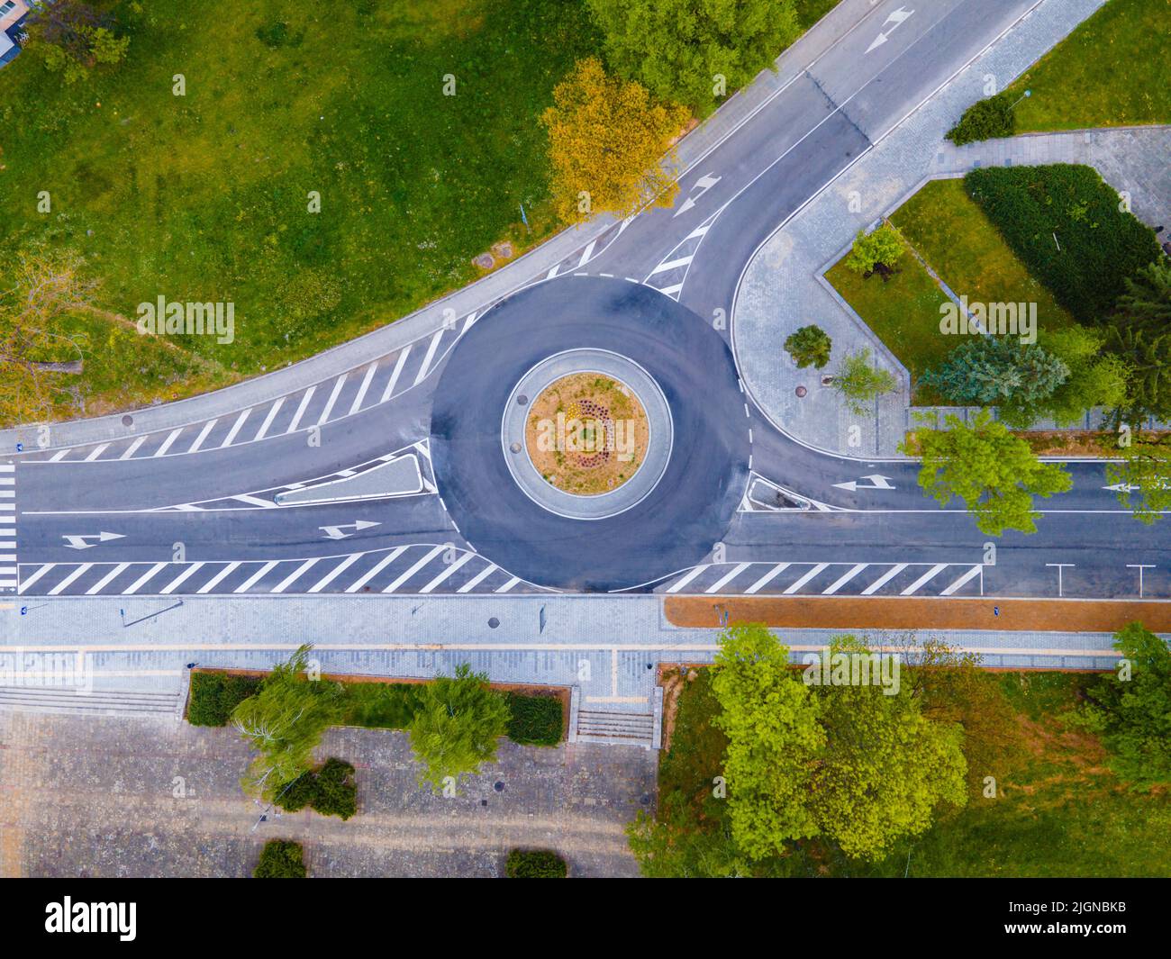 Top down aerial view of a traffic roundabout on a main road in a city ...