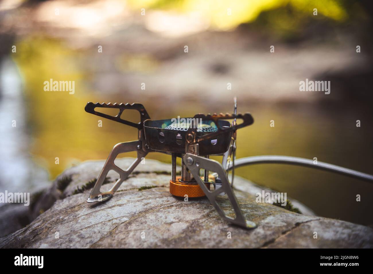 Cooking food using camping gas during the hike Stock Photo - Alamy