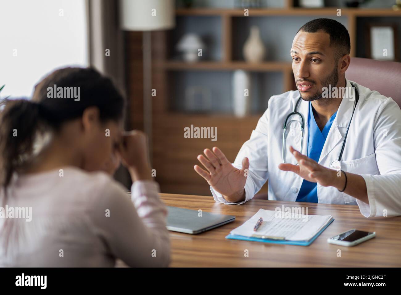 Middle eastern doctor having conversation with upset lady patient Stock ...