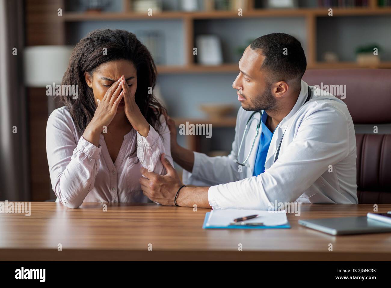 Practitioner consoling crying woman patient, clinic interior Stock ...